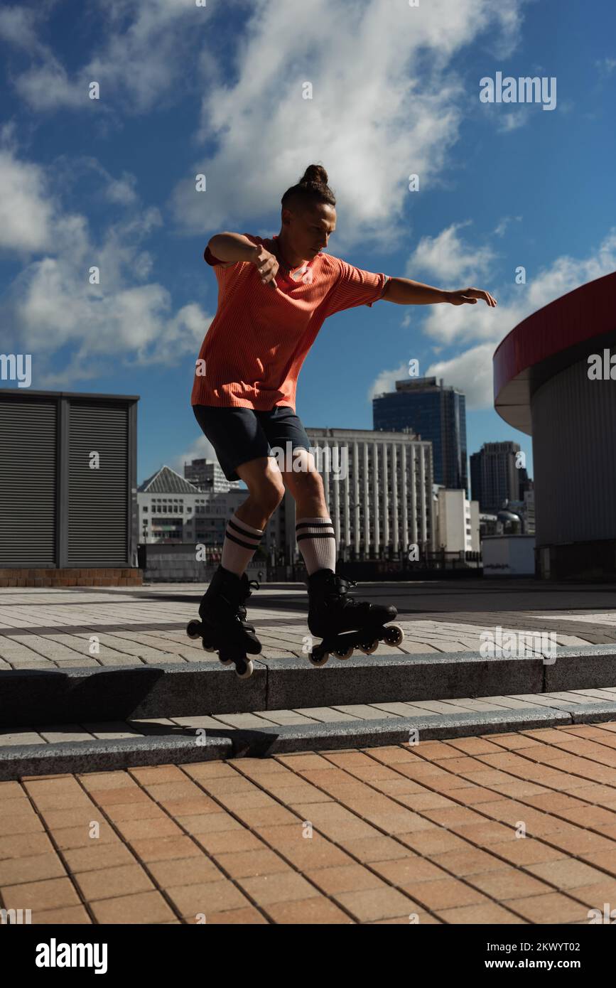 stylish roller skater jumping from stairs while doing trick on urban ...