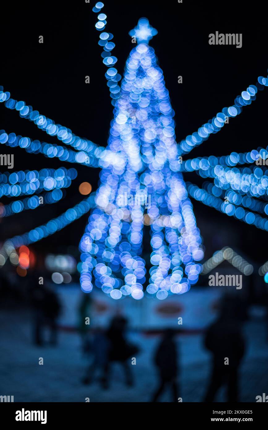 Bokeh silhouette of Christmas tree. Christmas tree with decorations and ...