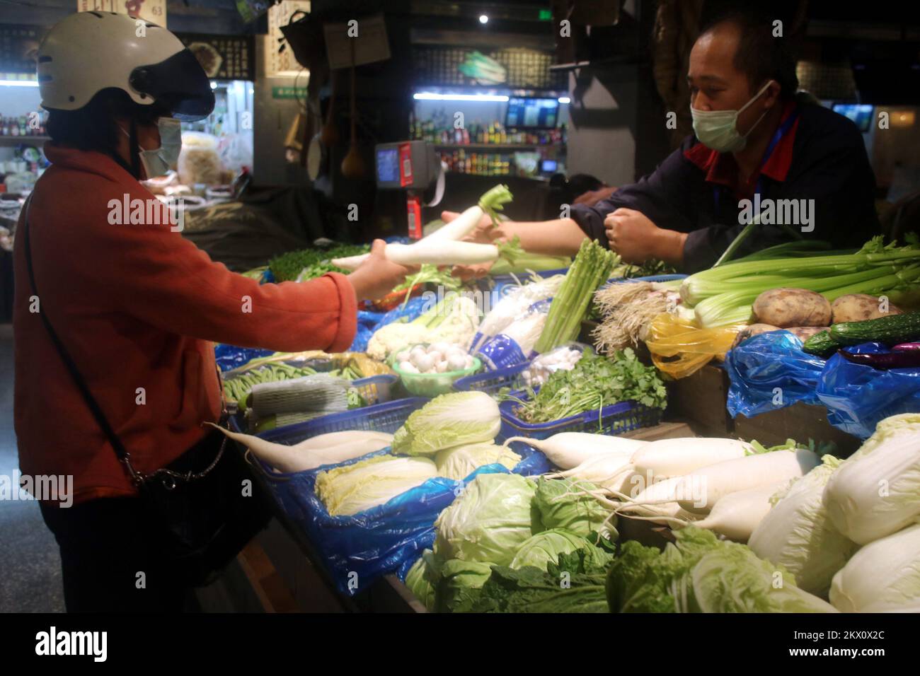 SUZHOU, CHINA - NOVEMBER 30, 2022 - People shop for vegetables at a ...
