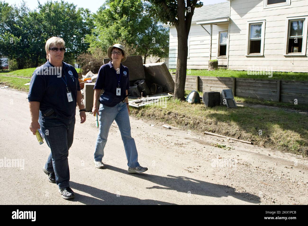 Residents walk through flooding hi-res stock photography and images - Alamy
