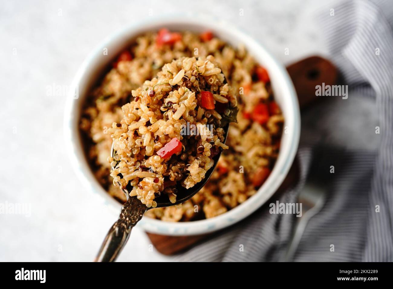 Quinoa brown rice pulao with red pepper served in a bowl- healthy ...