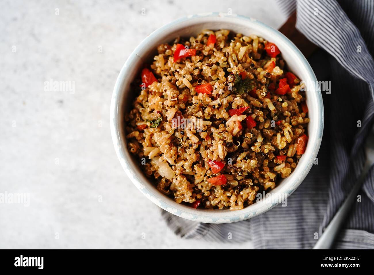 Quinoa brown rice pulao with red pepper served in a bowl- healthy ...