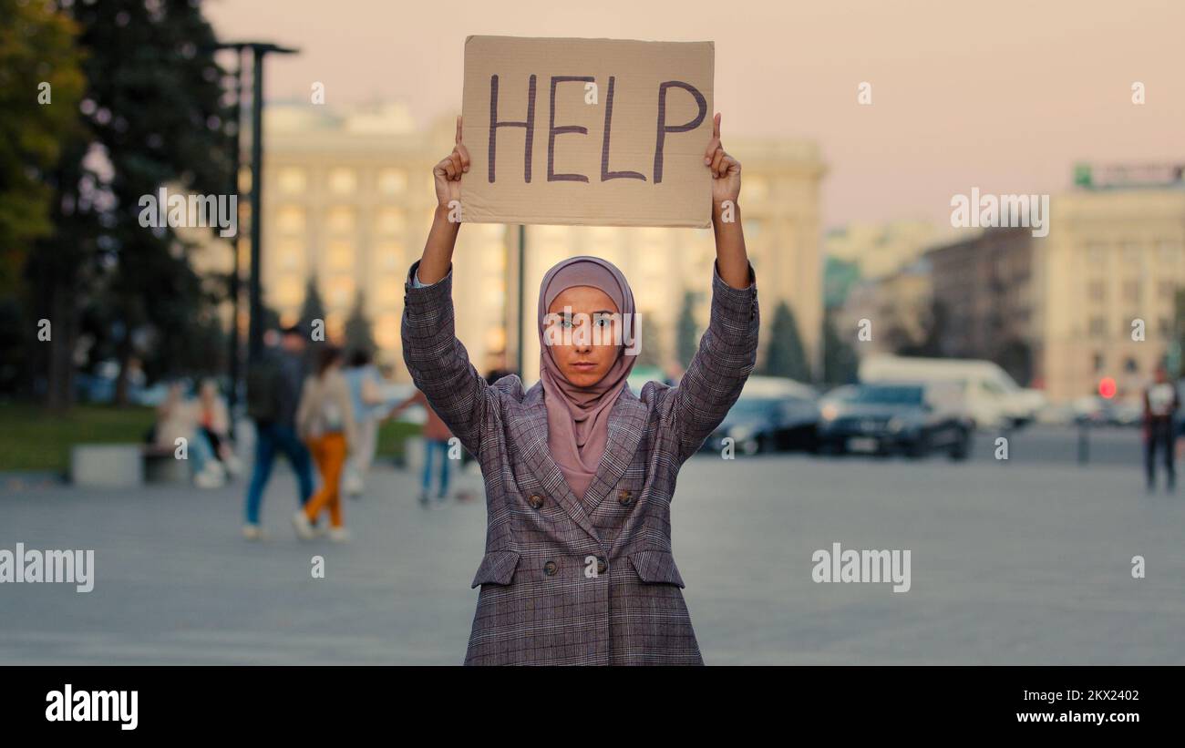 Sad lonely poor muslim girl wears hijab woman stands in city looking at ...