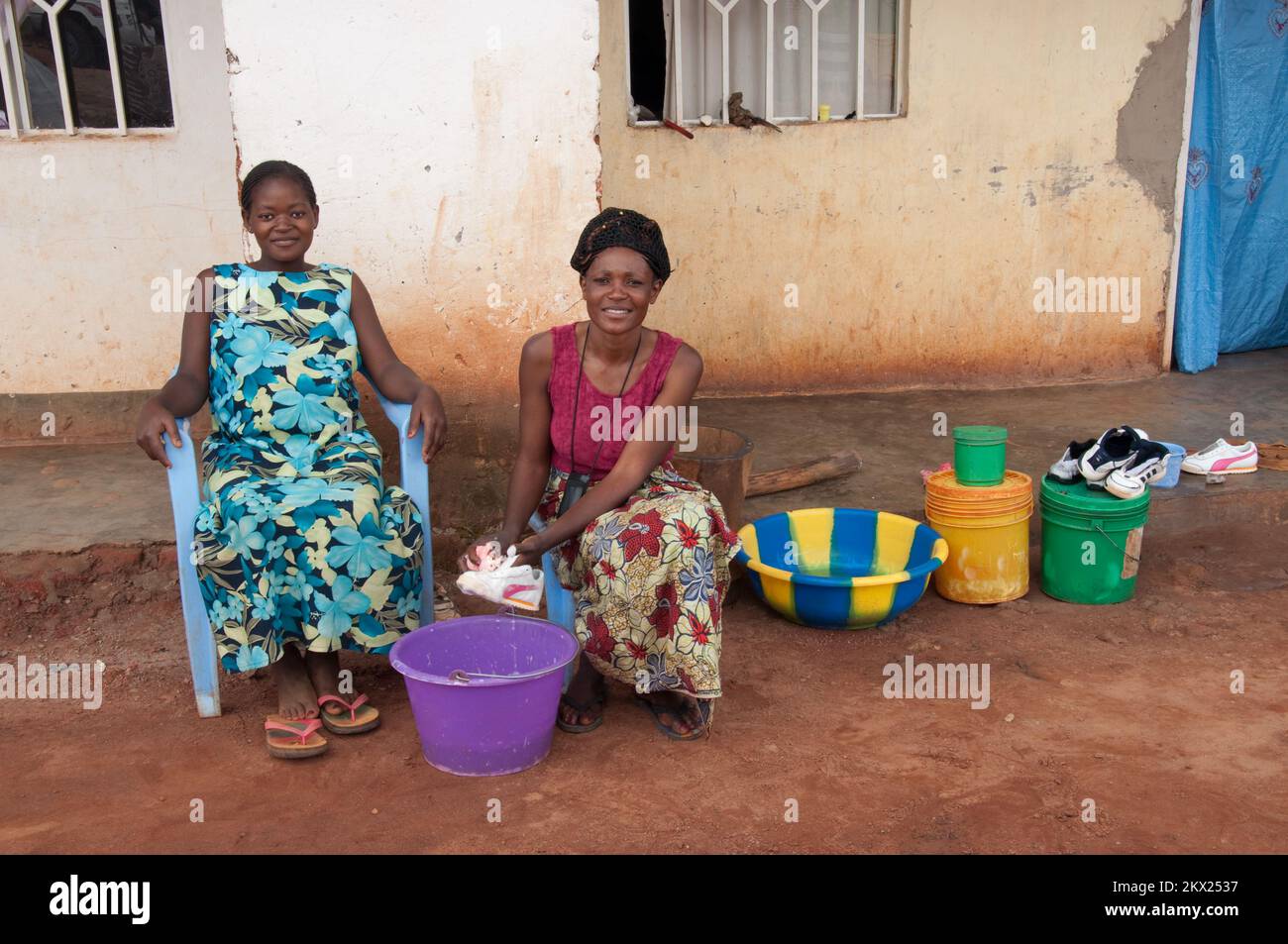 Women chatting and working in front of their houses hi-res stock ...
