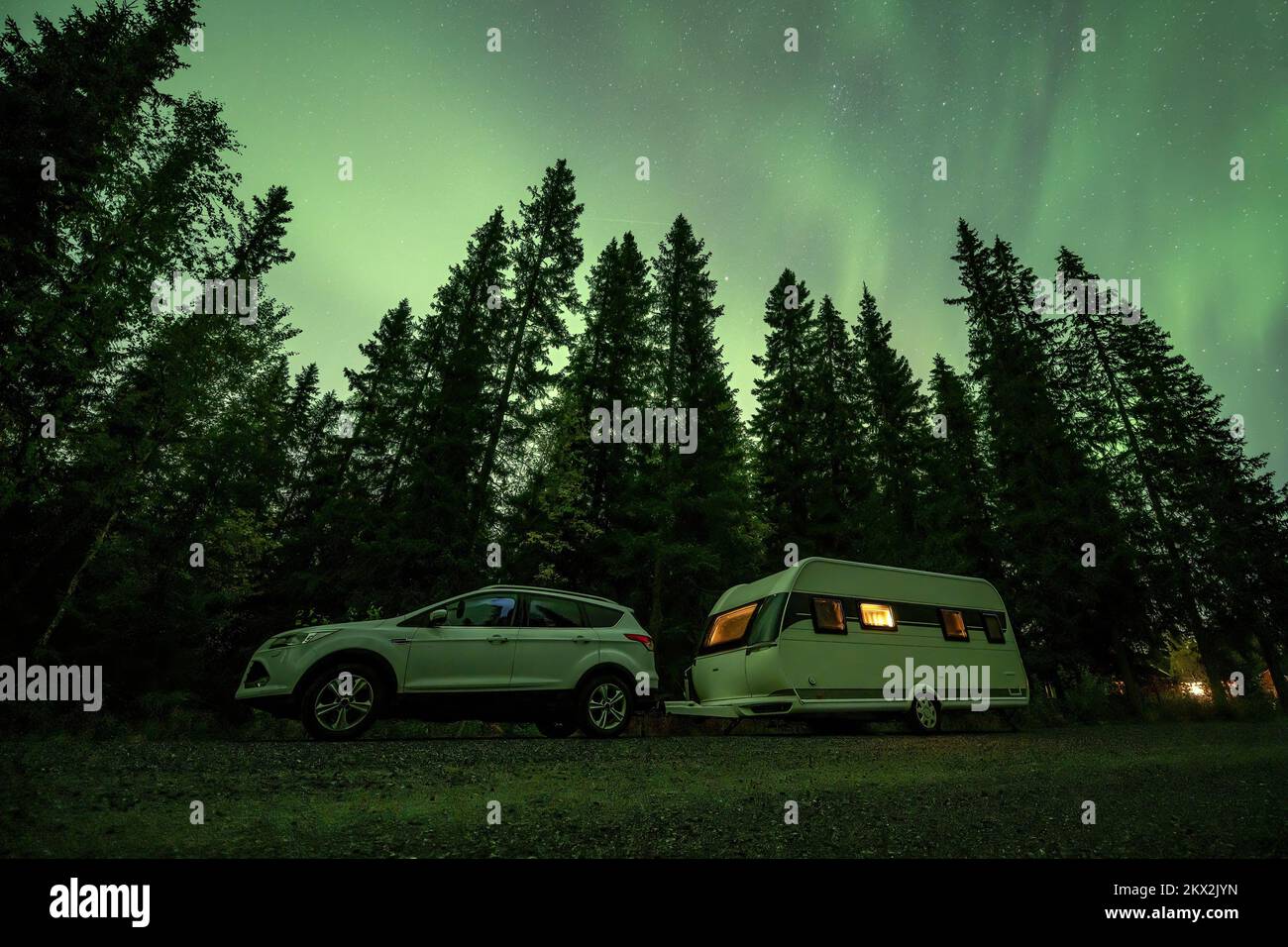 Aurora shining over Camping Caravan in Swedish forest landscape ...