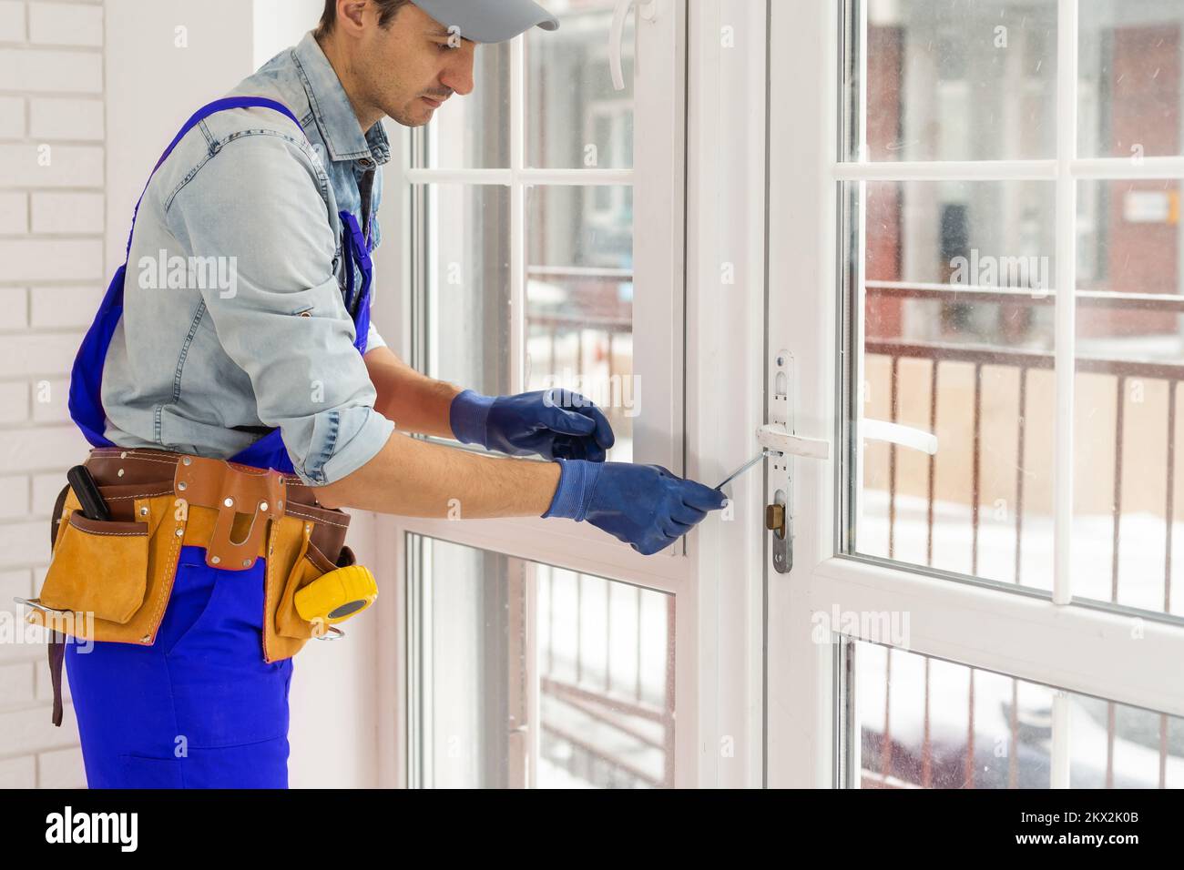 Construction worker installing window in house Stock Photo - Alamy