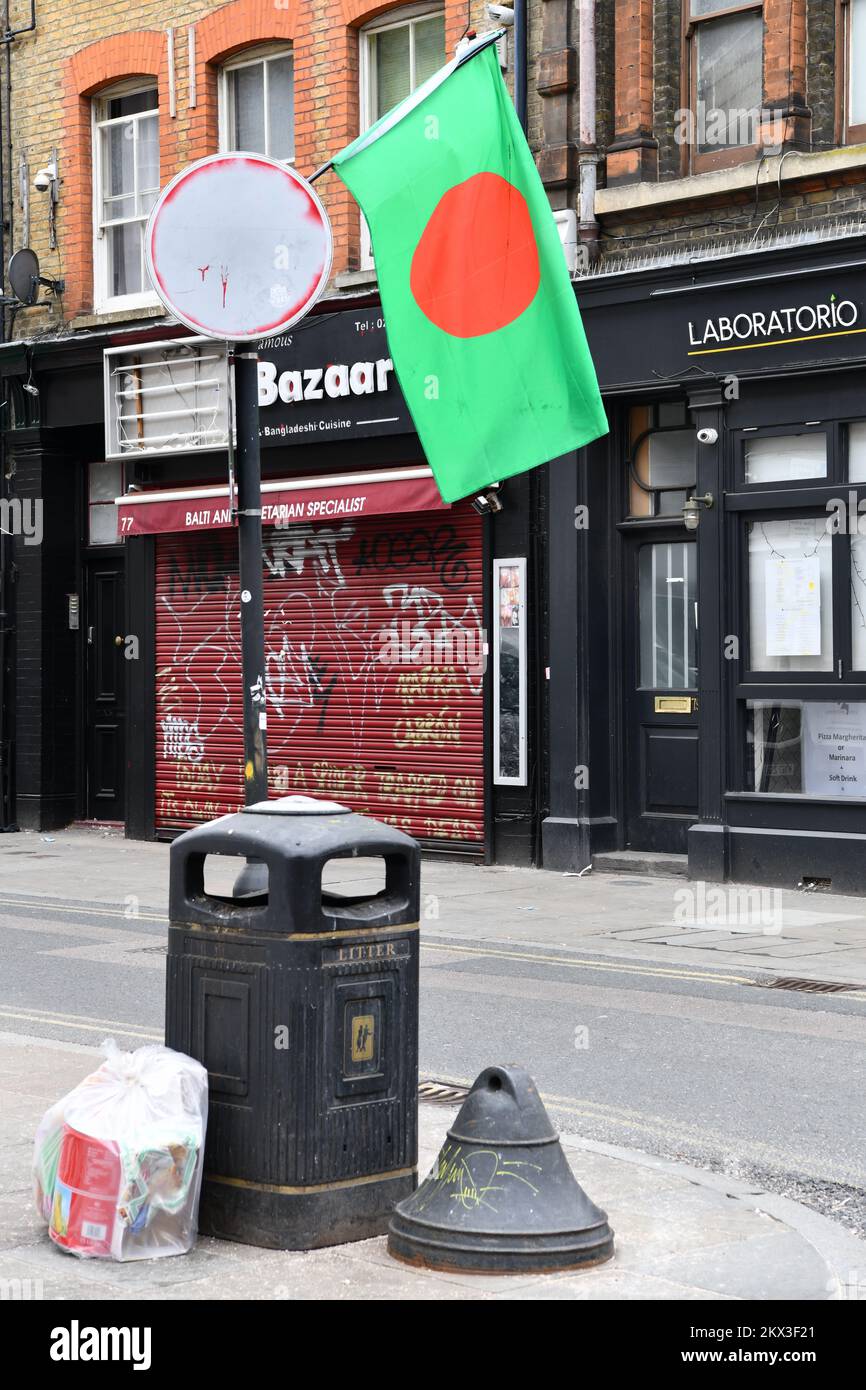 Bangladeshi national flag flying from painted over road sign above a ...