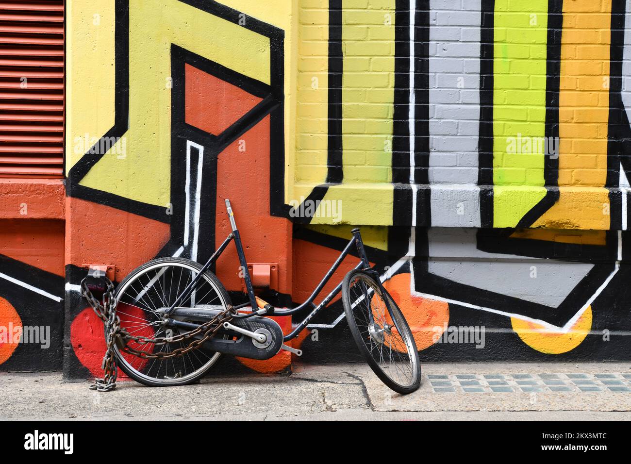 Bicycle with parts stolen or missing chained to building covered in ...
