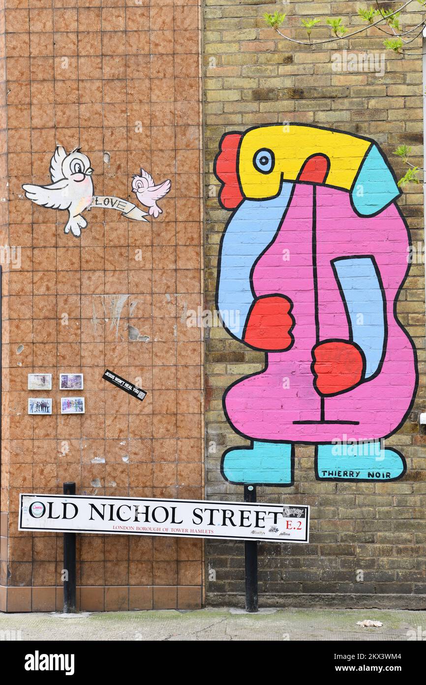 Coloured figure by artist and muralist, Thierry Noir, on the corner of ...