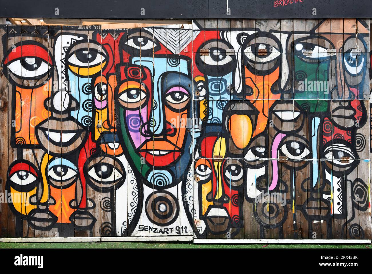Street art faces by Senzart 911 on wooden shutters on Hanbury Street ...