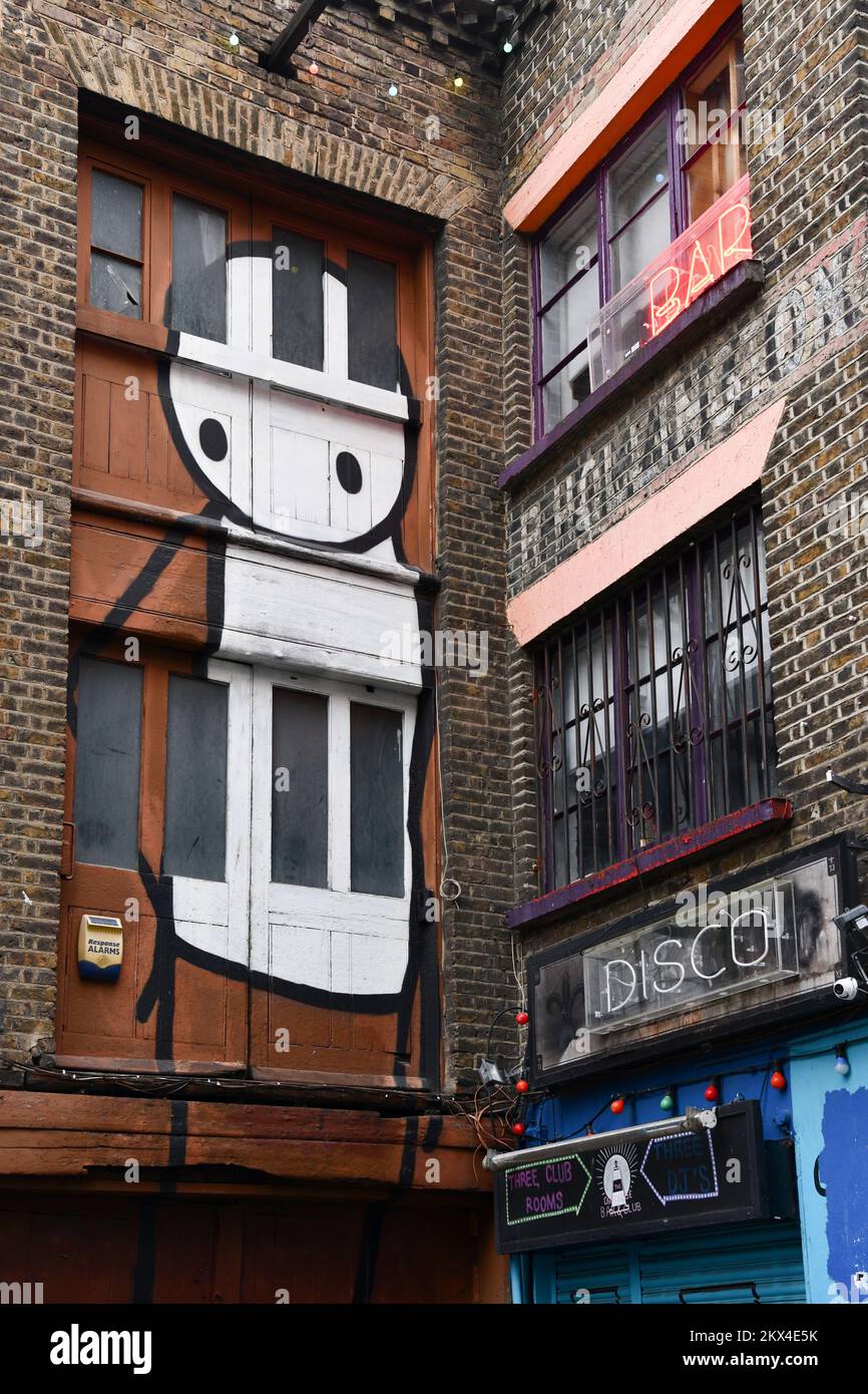 White stick figure on brown background painted by Stik on nightclub in ...