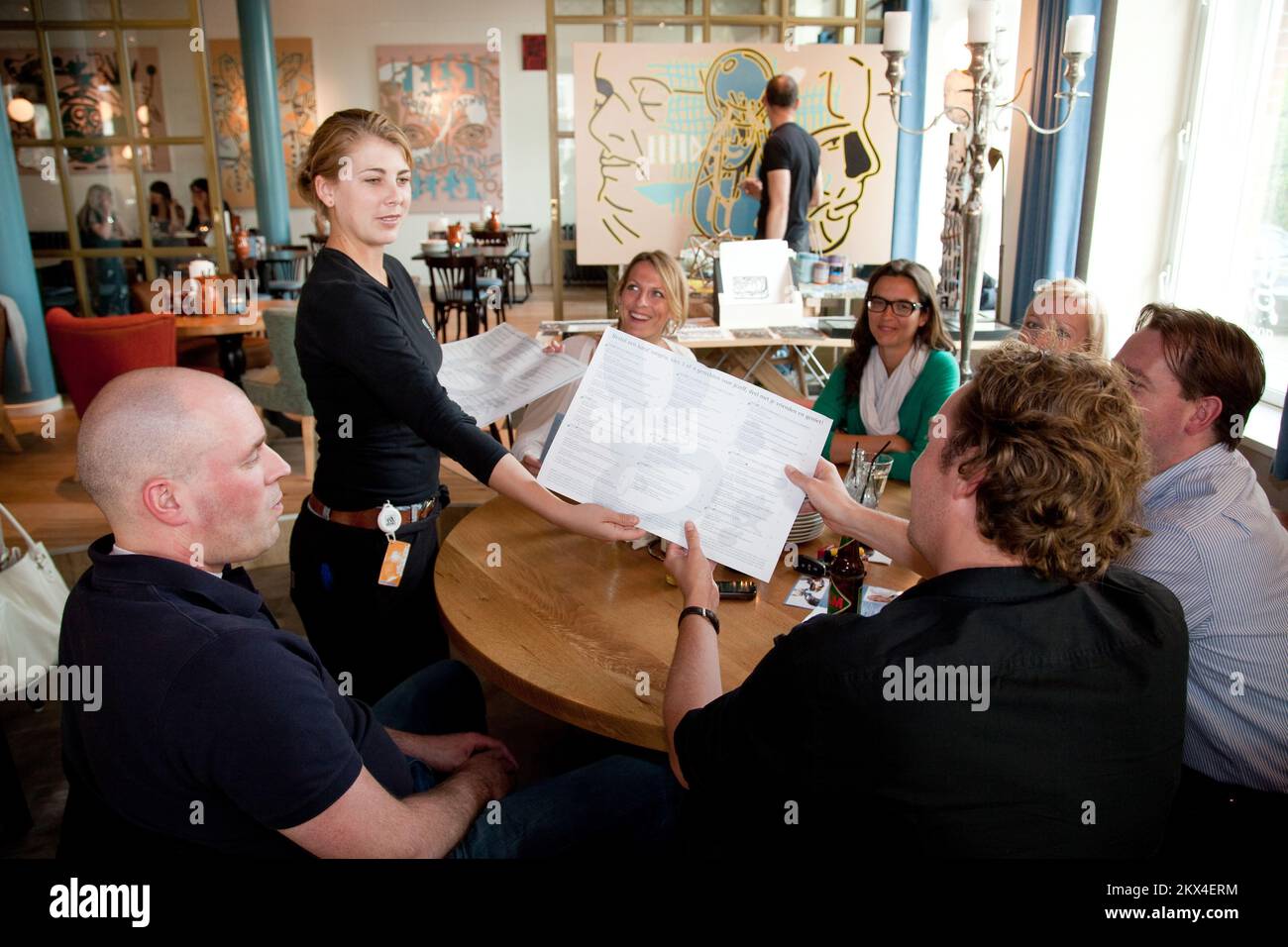 Netherlands, waitress hands out menus to guests in a restaurant Stock ...