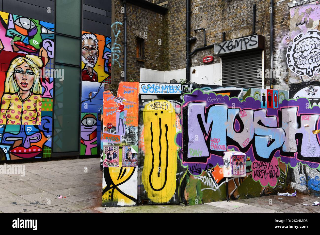 A mix of graffiti and street art at back of a building in Shoreditch ...