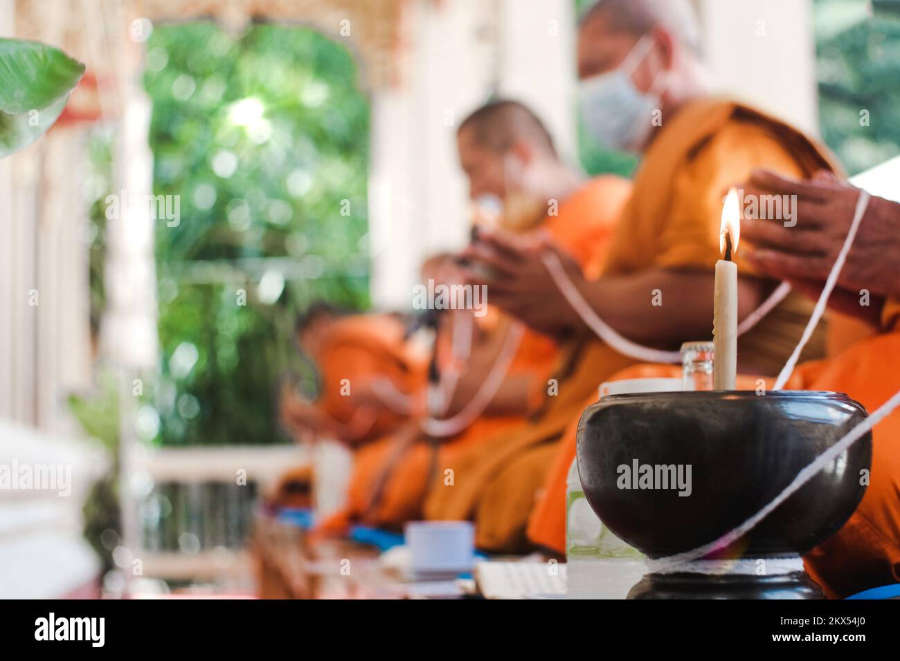 Buddhist monks chant a ritual with candles as the main element of the ...