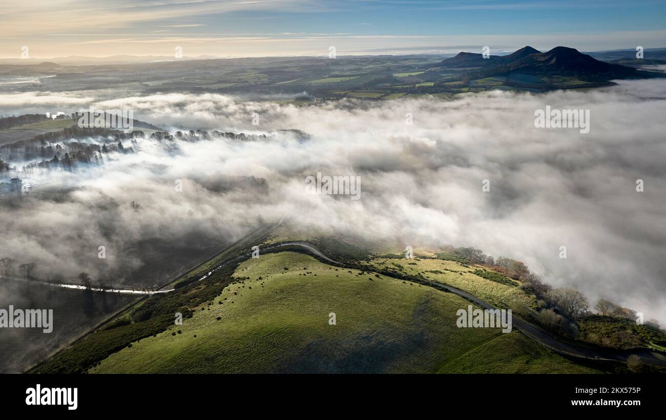 Aerial view of a cloud inversion around the Eildons and the River Tweed ...