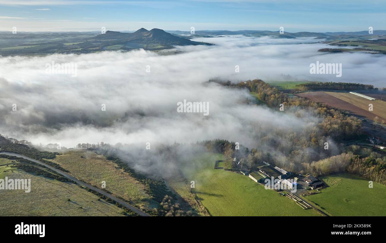 Aerial view of a cloud inversion around the Eildons and the River Tweed ...