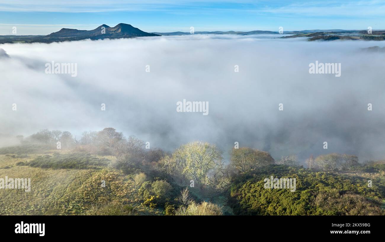 Aerial view of a cloud inversion around the Eildons and the River Tweed ...