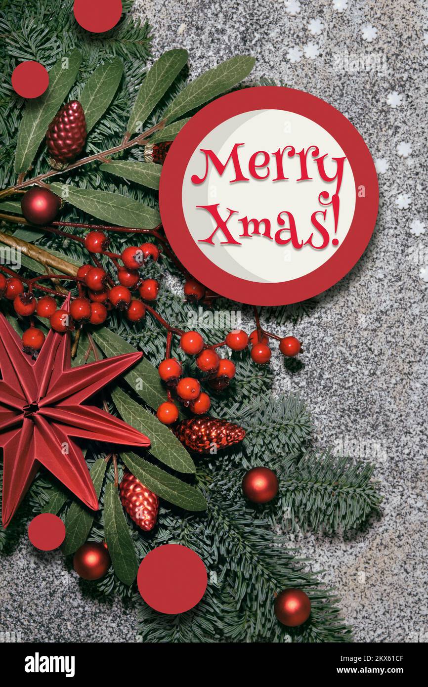 Merry Xmas text, greeting on round Christmas paper card. Flat lay with ...