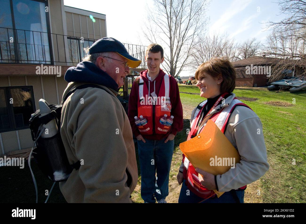 Red Cross Disaster Mental Health (DMH) team talking with flood a ...