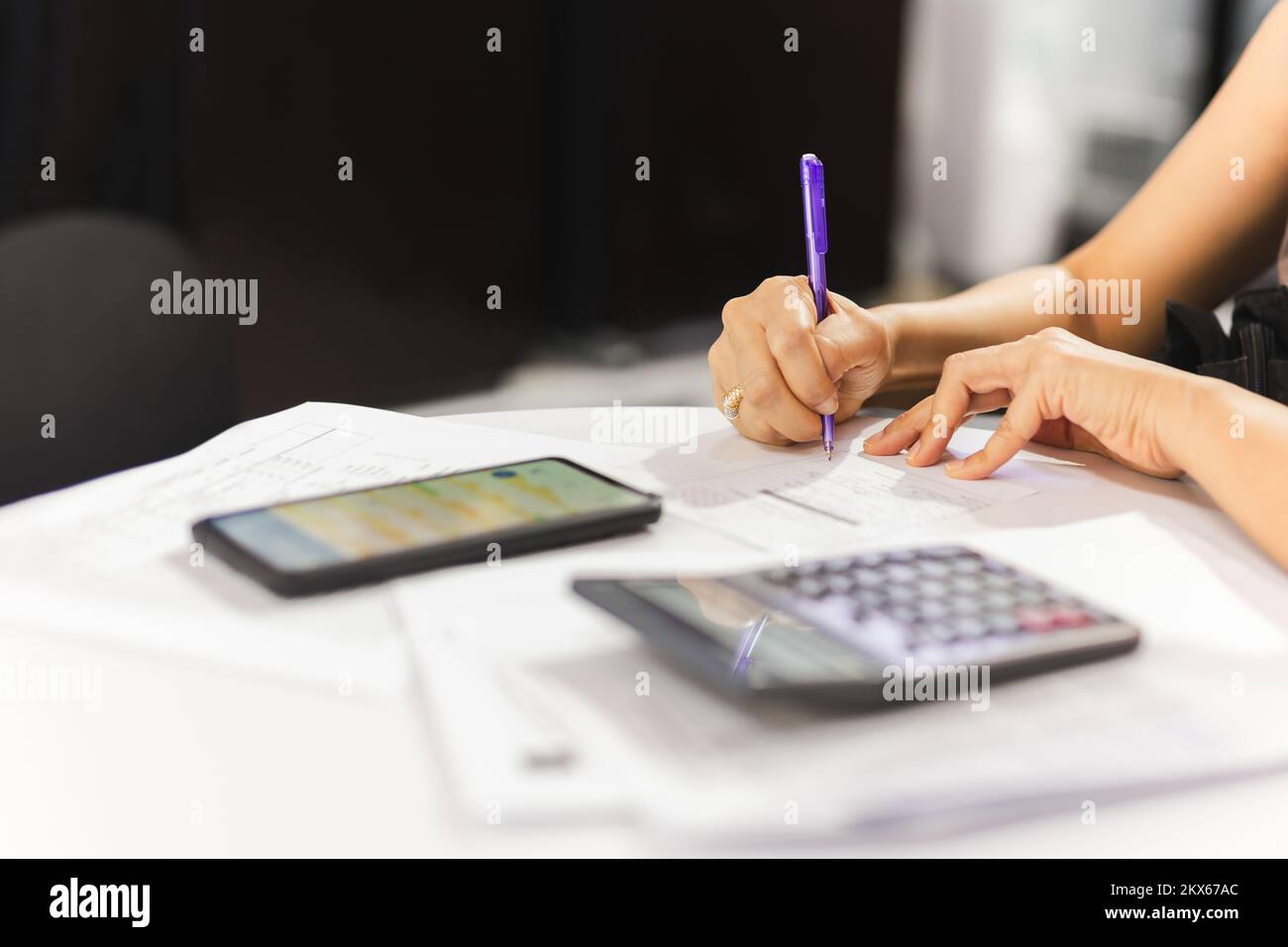 Businesswoman signing document signature agreement with cell phone on ...