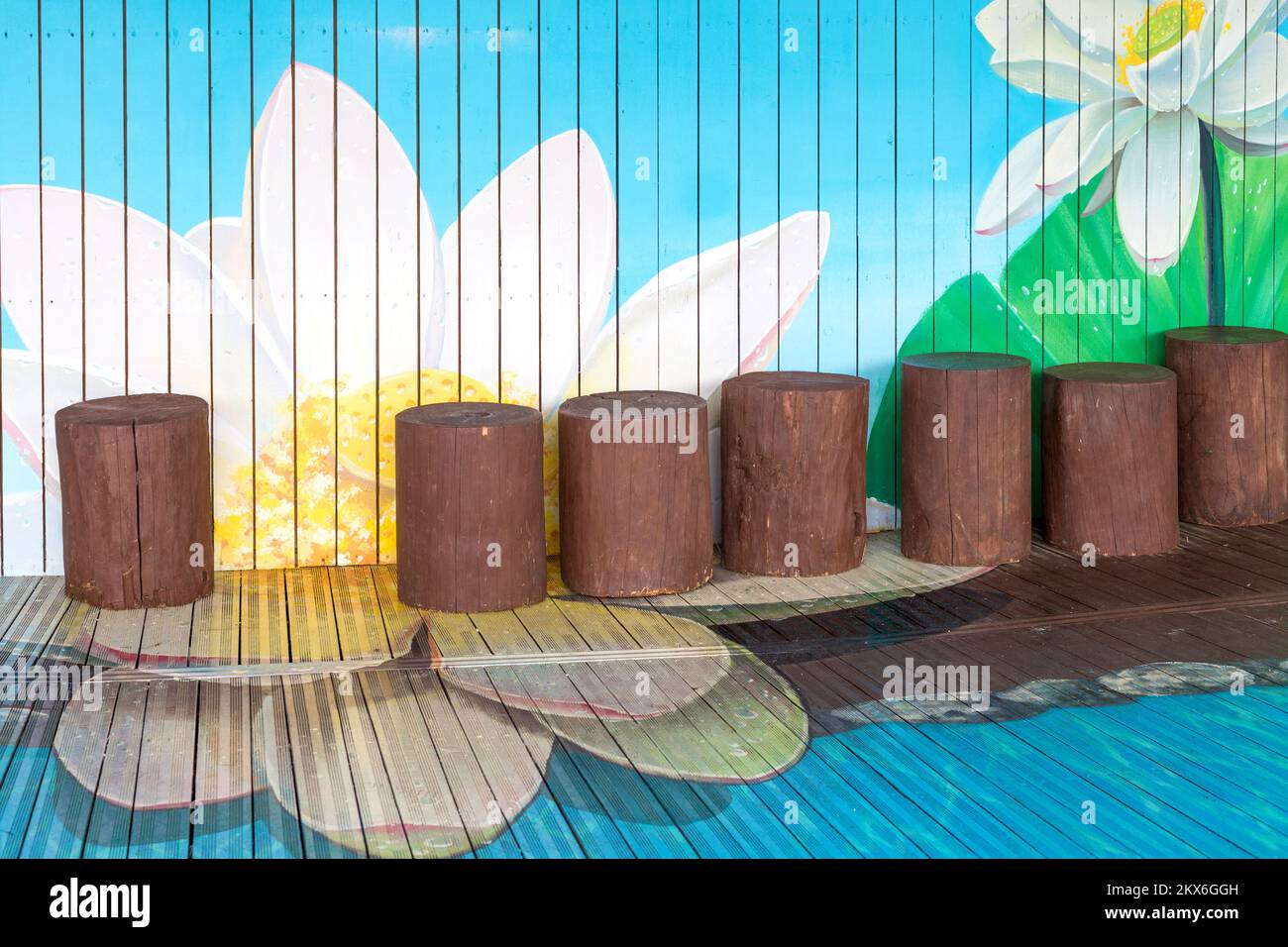 log chairs under lotus murals Stock Photo - Alamy