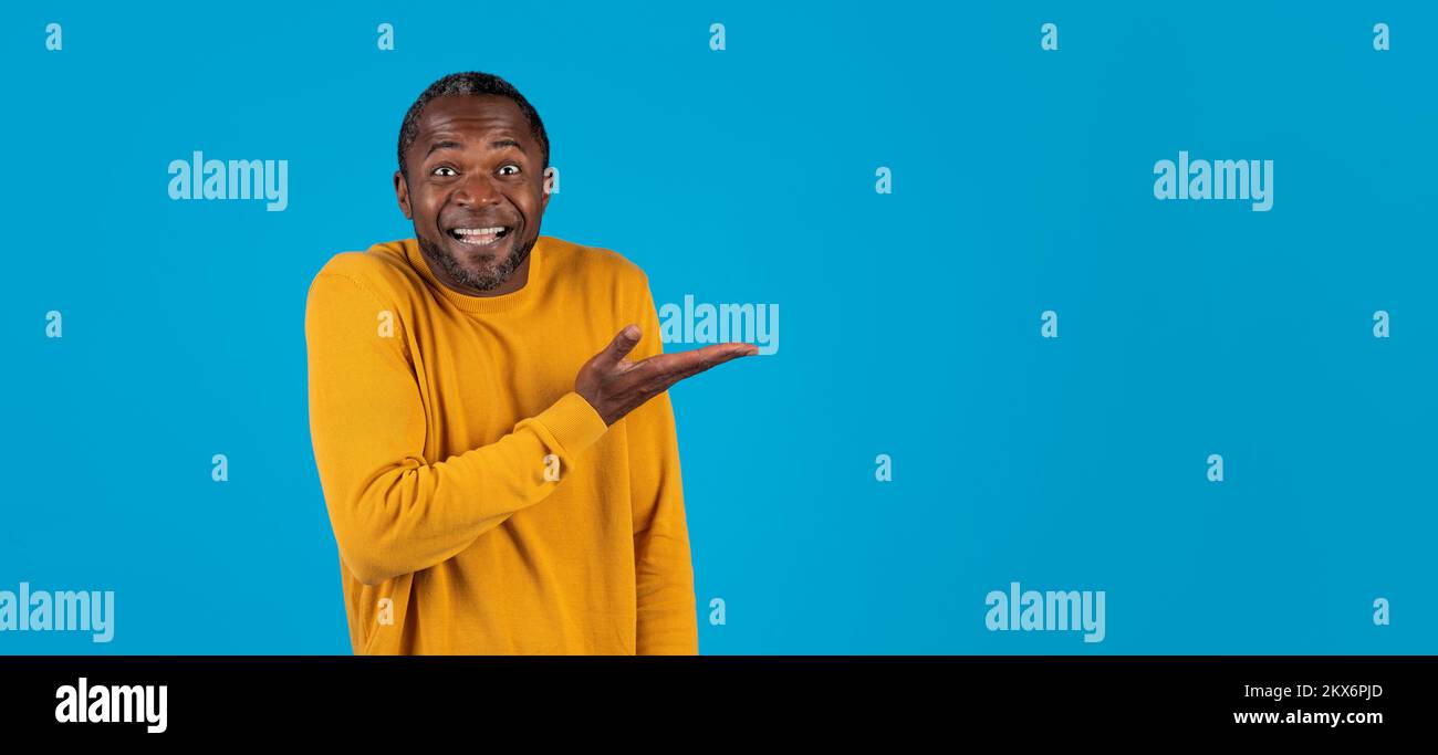 Amazed mature black man showing empty space for advertisement Stock ...