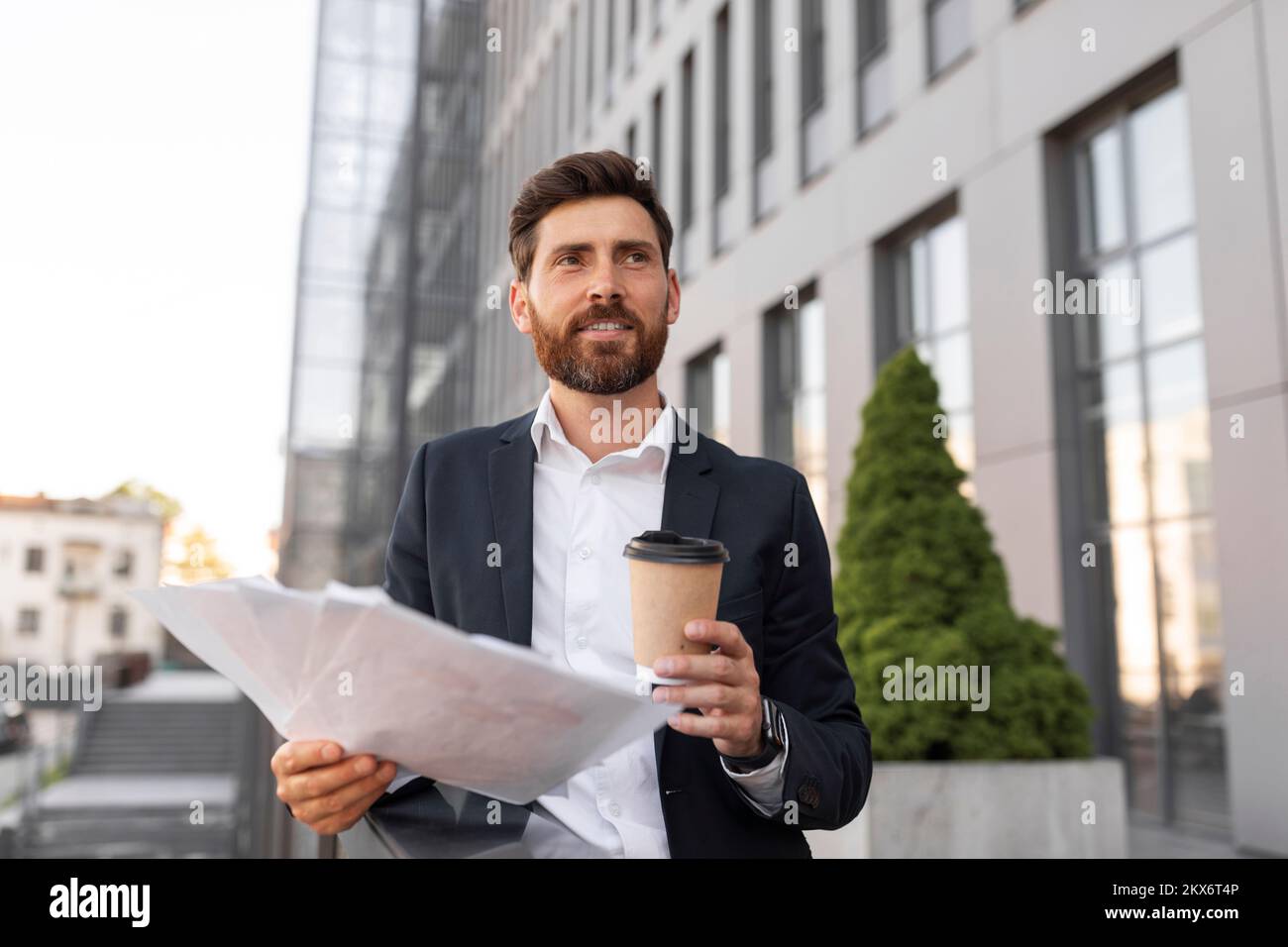 Cheerful confident young european guy boss with beard in suit with ...