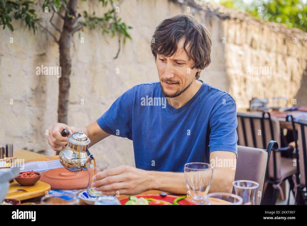 Man eating turkish breakfast. Turkish breakfast table. Pastries ...