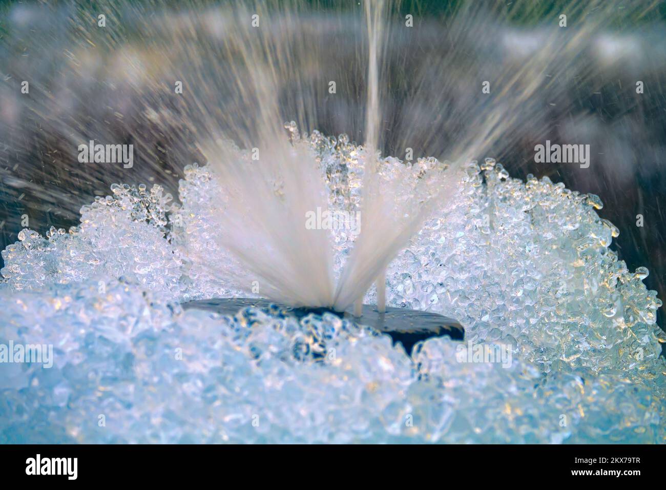 Water gushes (leaky cap) from an artesian well enclosed in a pipe ...