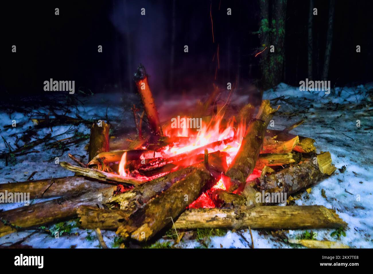 Bonfire winter dark night. Campfire in the winter forest at a halt ...