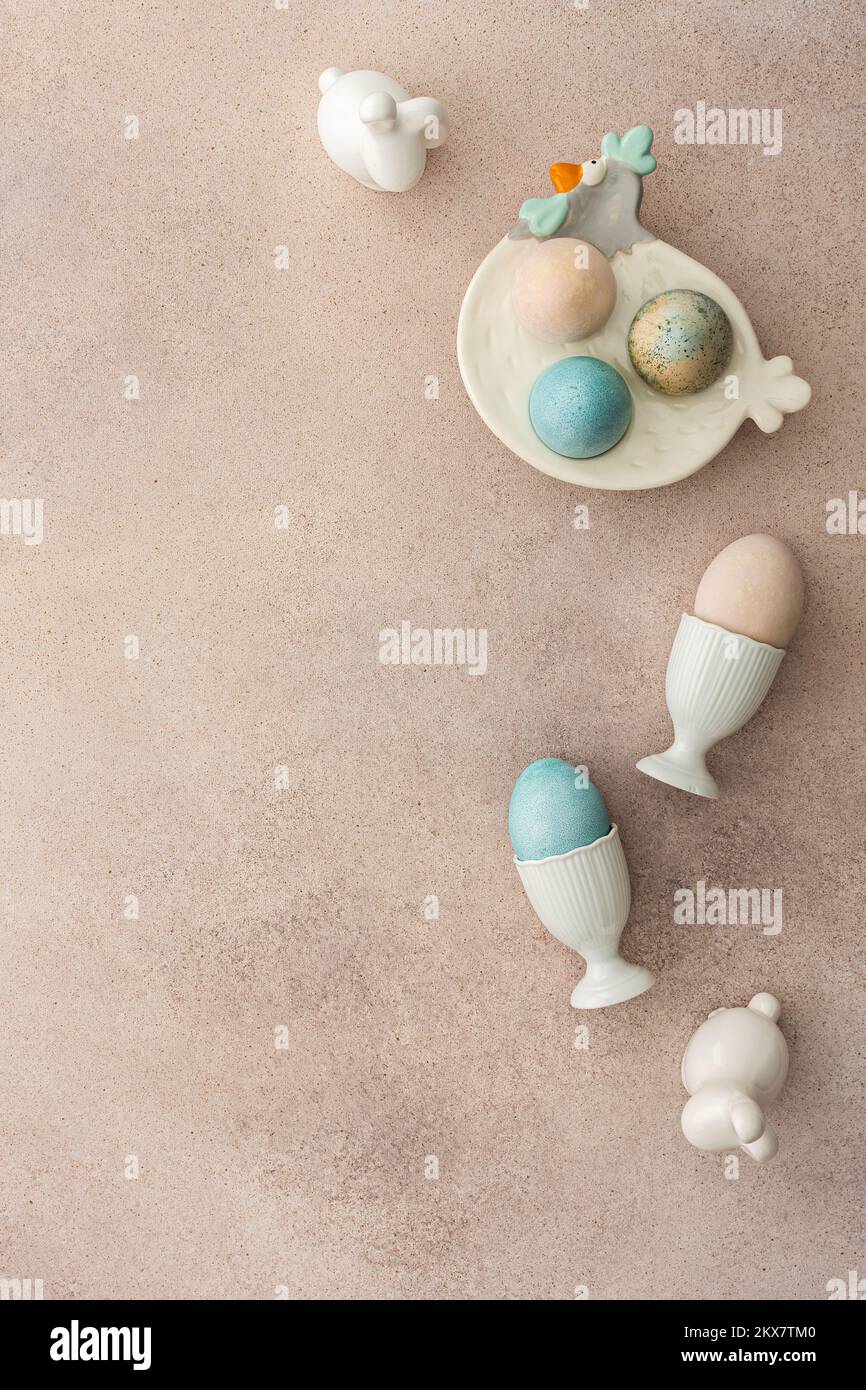 Colorful Easter eggs and cute bunnies on a pastel pink background, top ...