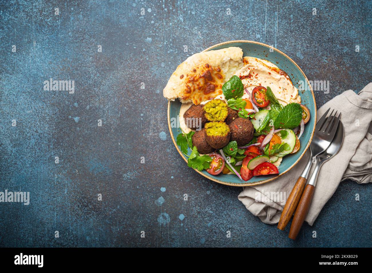 Middle Eastern Arab meal with fried falafel, hummus, vegetables salad ...