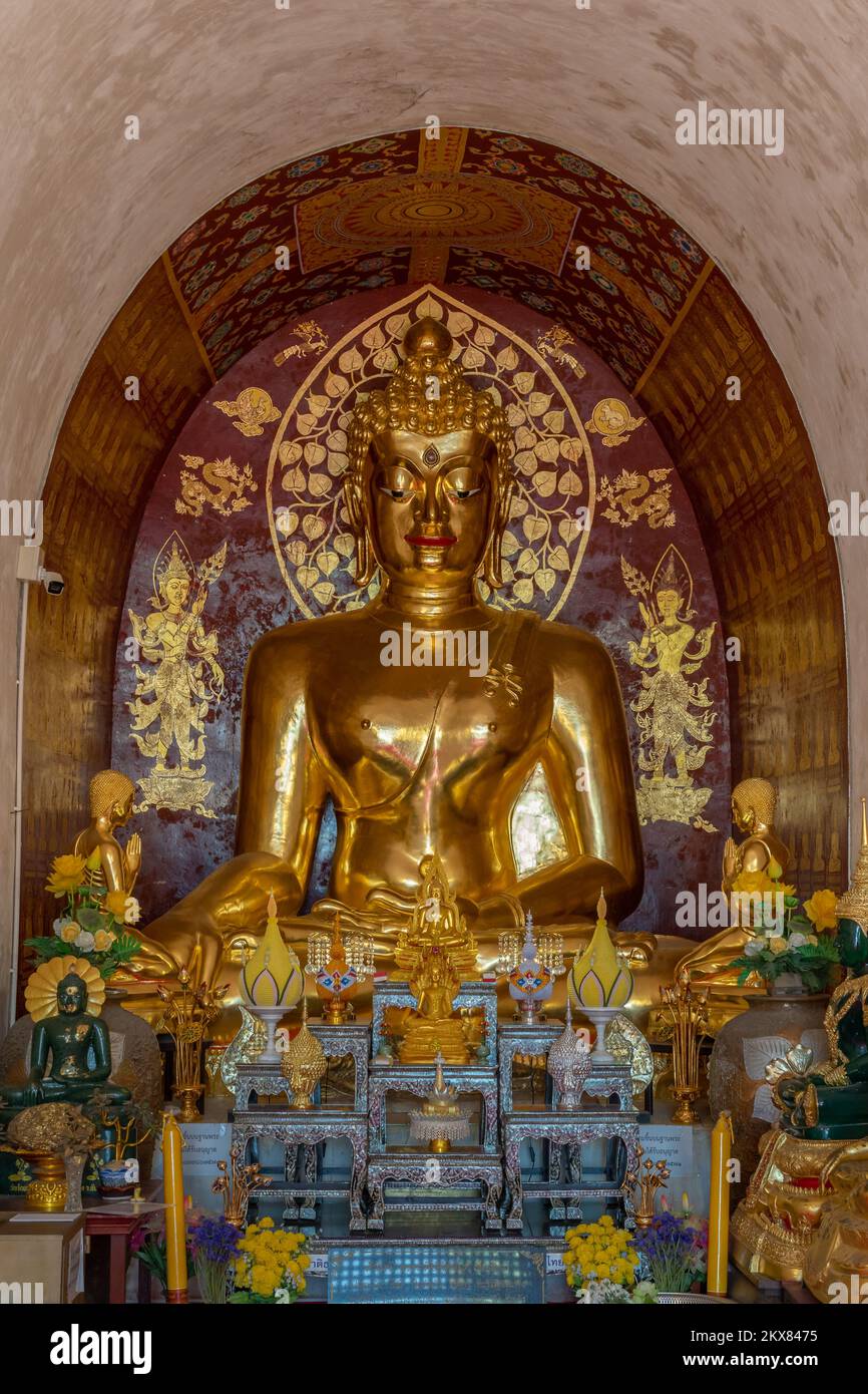 Ancient Buddha statues with red and gold stencil background inside main ...