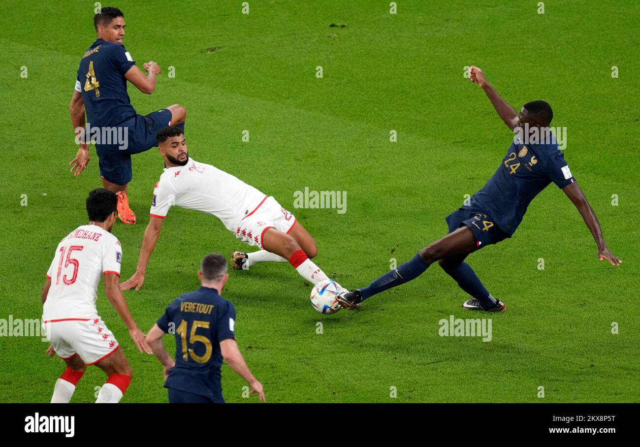 Al Rayyan, Qatar. 30th Nov, 2022. Ibrahima Konate (R) of France vies ...