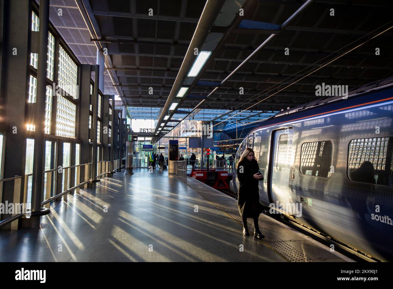 Silhouetted travellers and railway passengers with bags and suitcases ...
