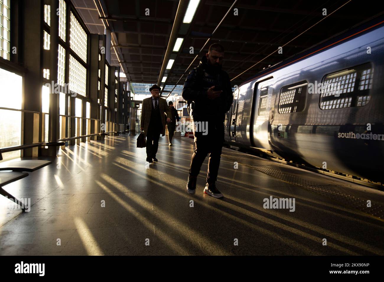 Silhouetted travellers and railway passengers with bags and suitcases ...
