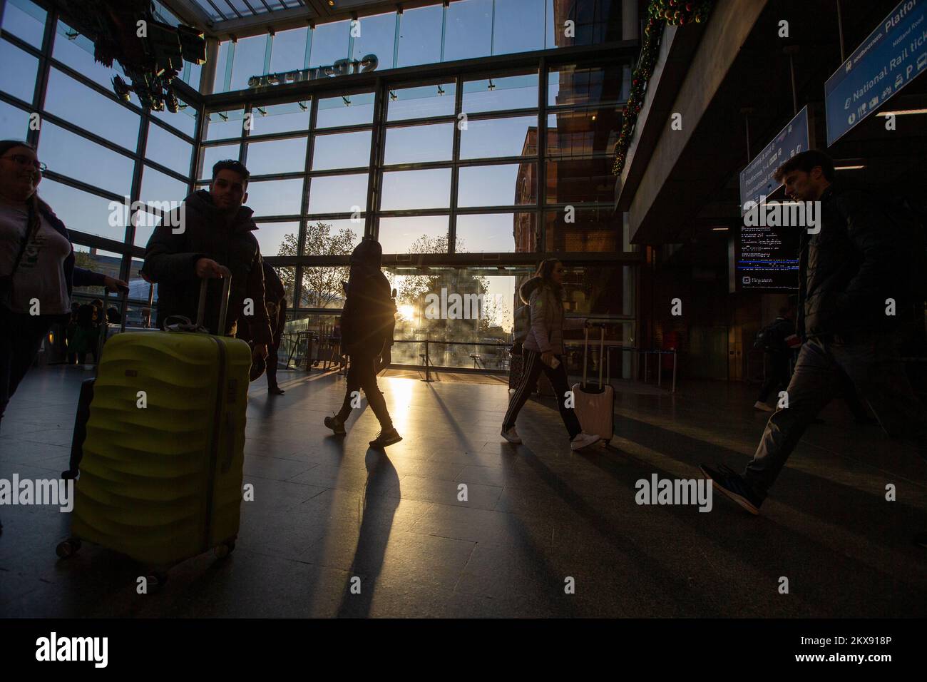 Silhouetted travellers and railway passengers with bags and suitcases ...
