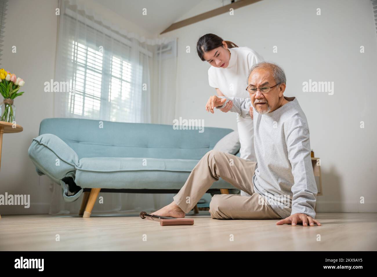 old man falling down lying on floor with walking stick and assistant ...