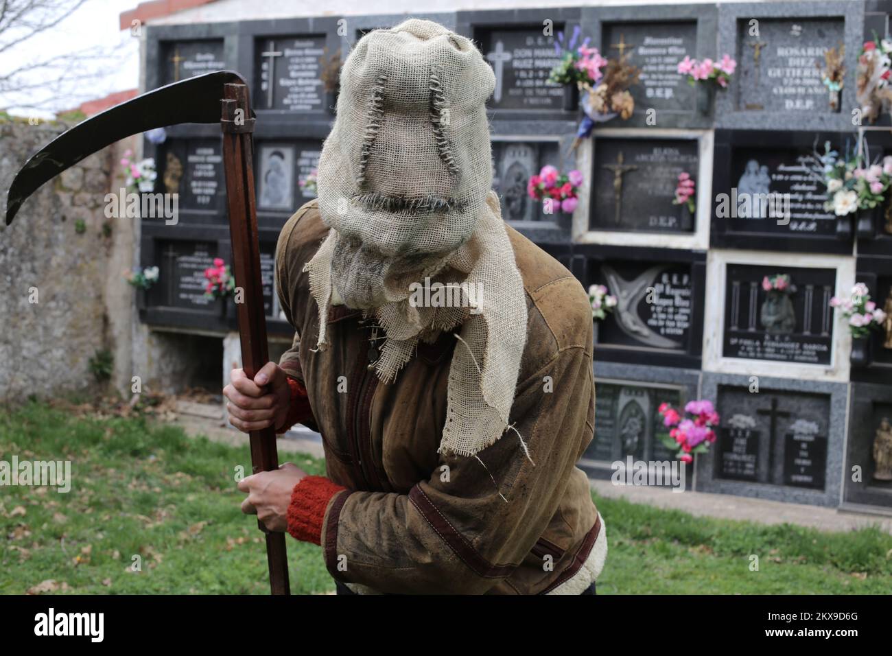 Spooky masked man in cemetery entrance Stock Photo - Alamy