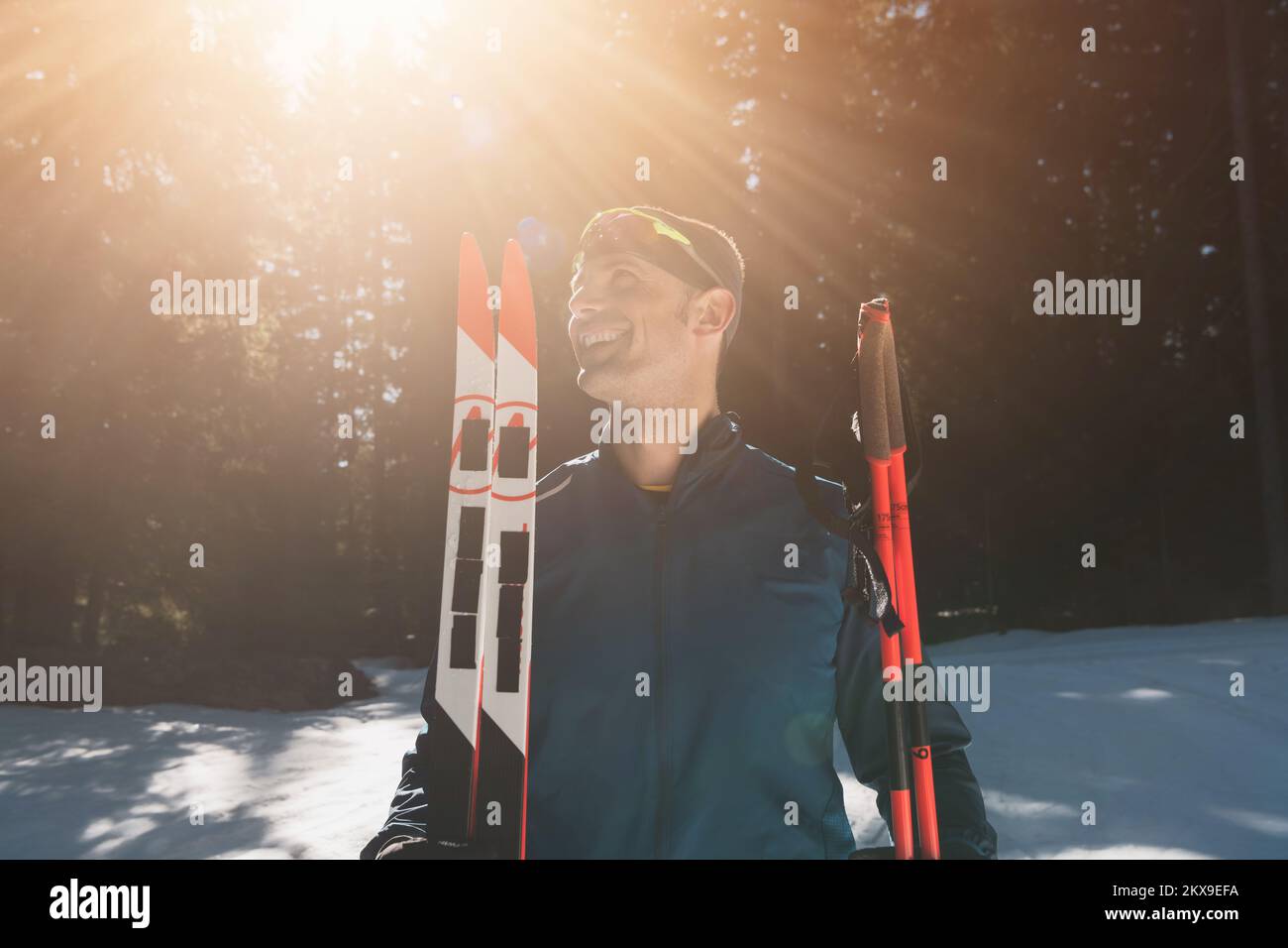 Portrait handsome male athlete with cross country skis in hands and ...