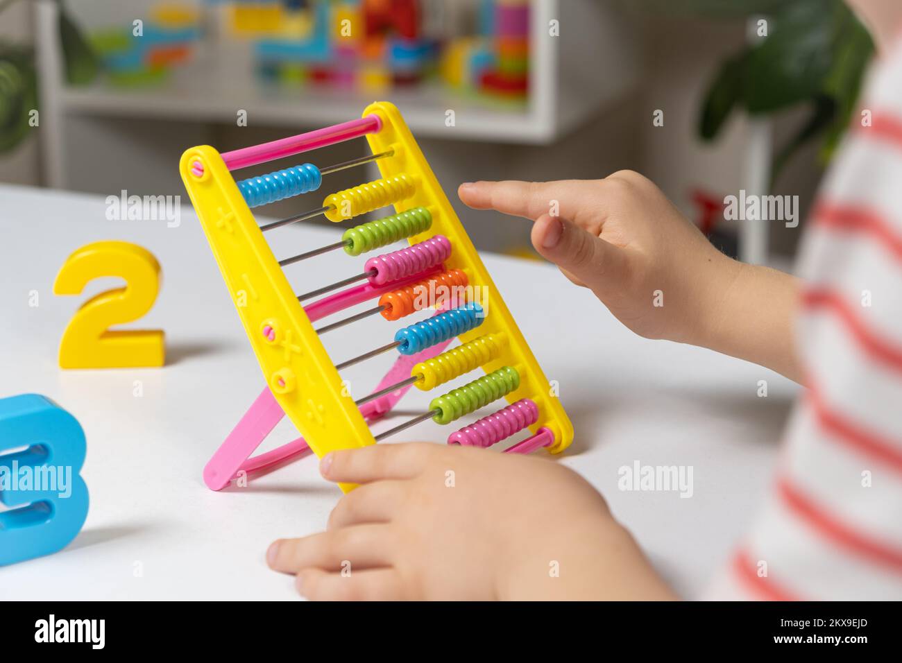 A small child learns to count on abacus, mathematics, arithmetic for ...