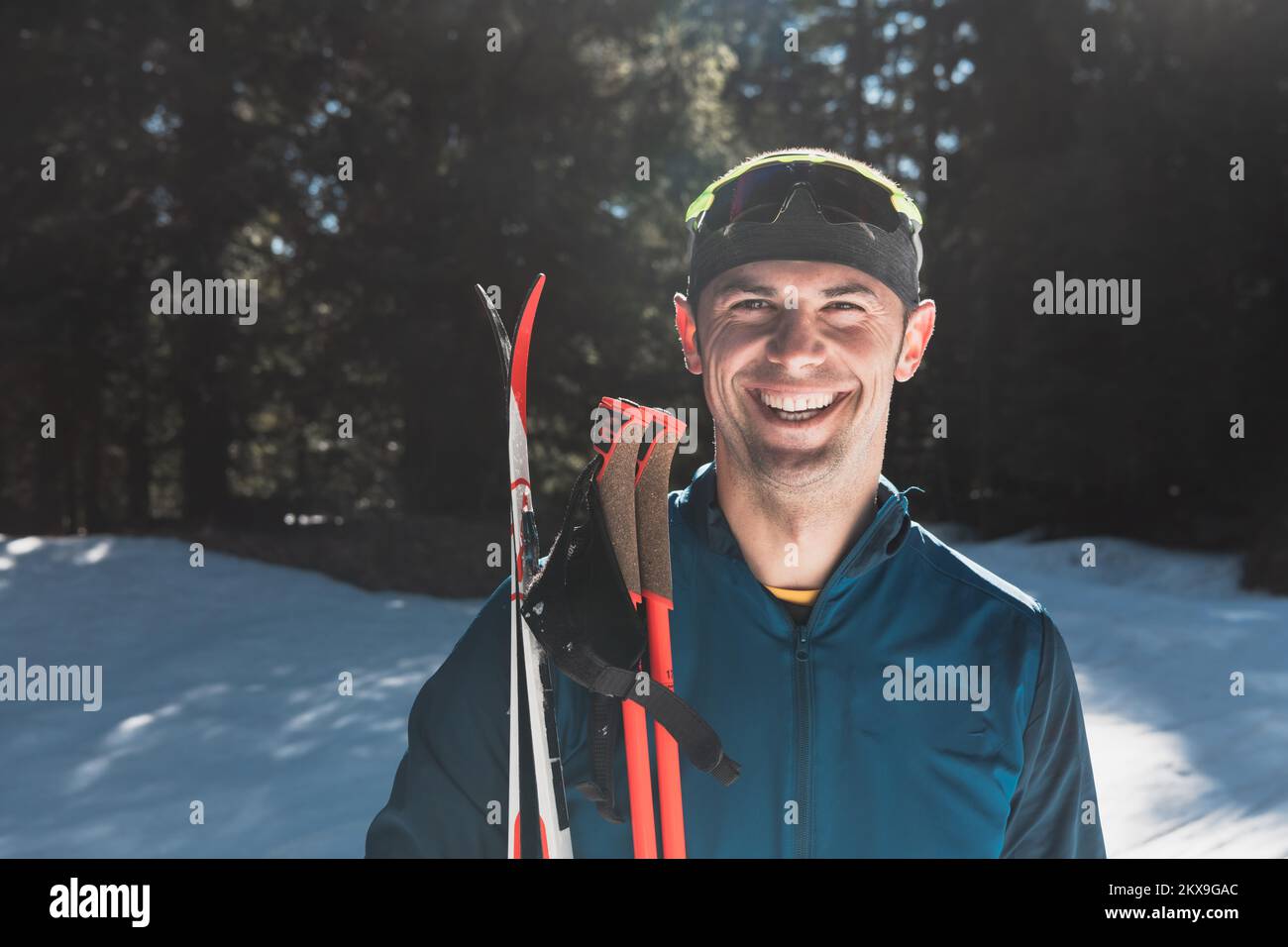Portrait handsome male athlete with cross country skis in hands and ...