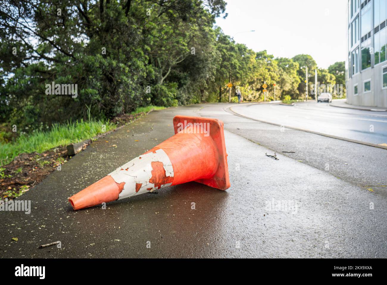 Orange traffic cone lying on the footpath. Auckland. New Zealand Stock ...
