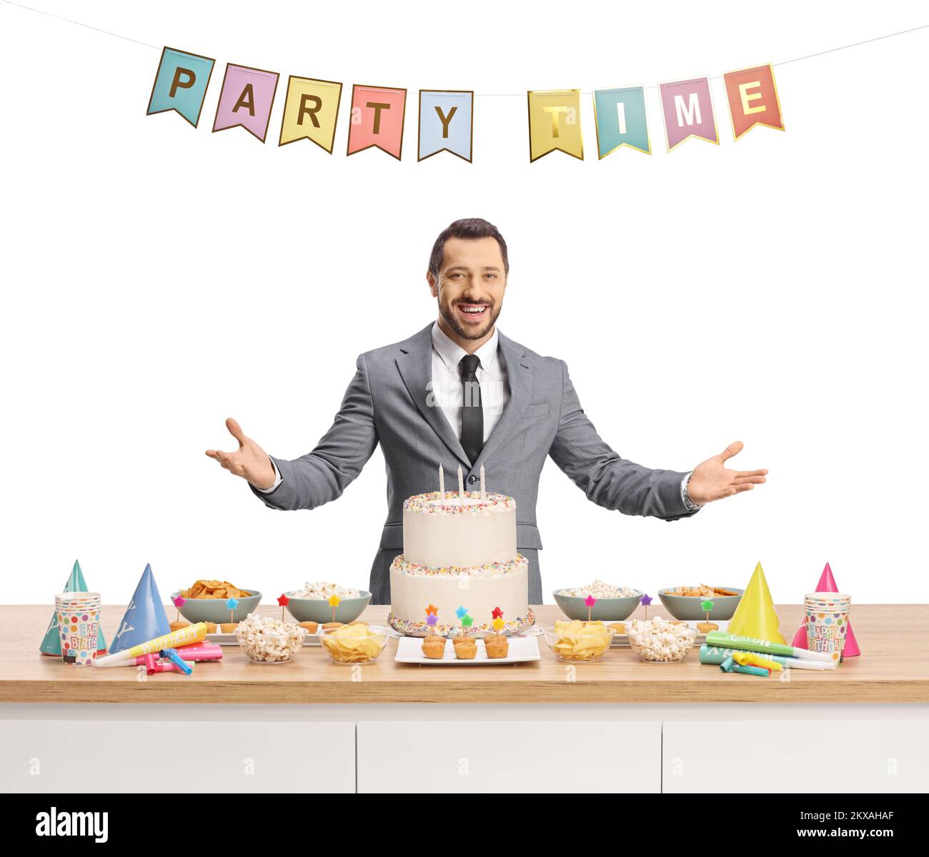 Man preparing for celebration with party time flags hanging and cake ...
