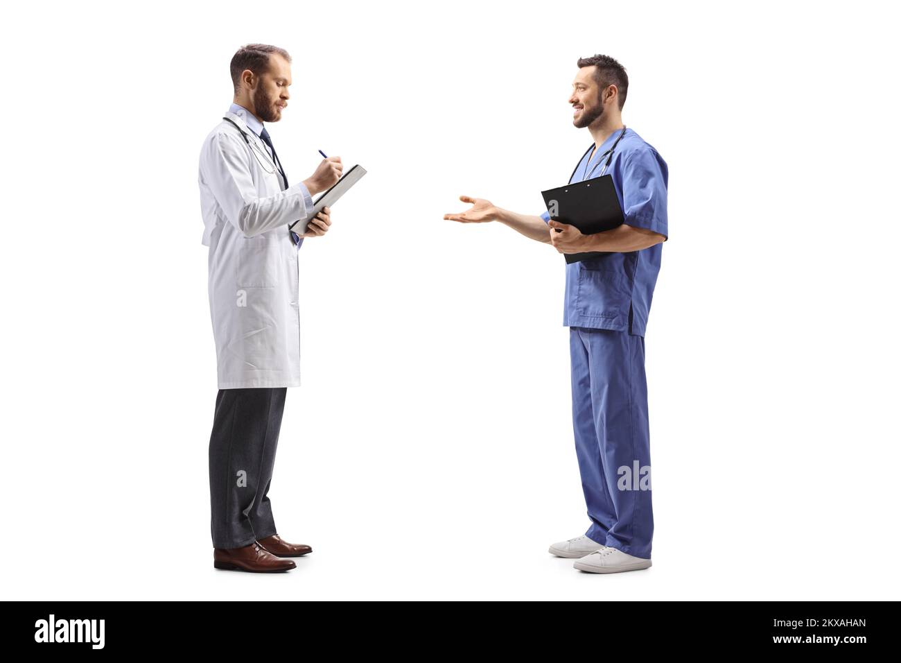 Full length profile shot of a male doctor standing and writing a ...