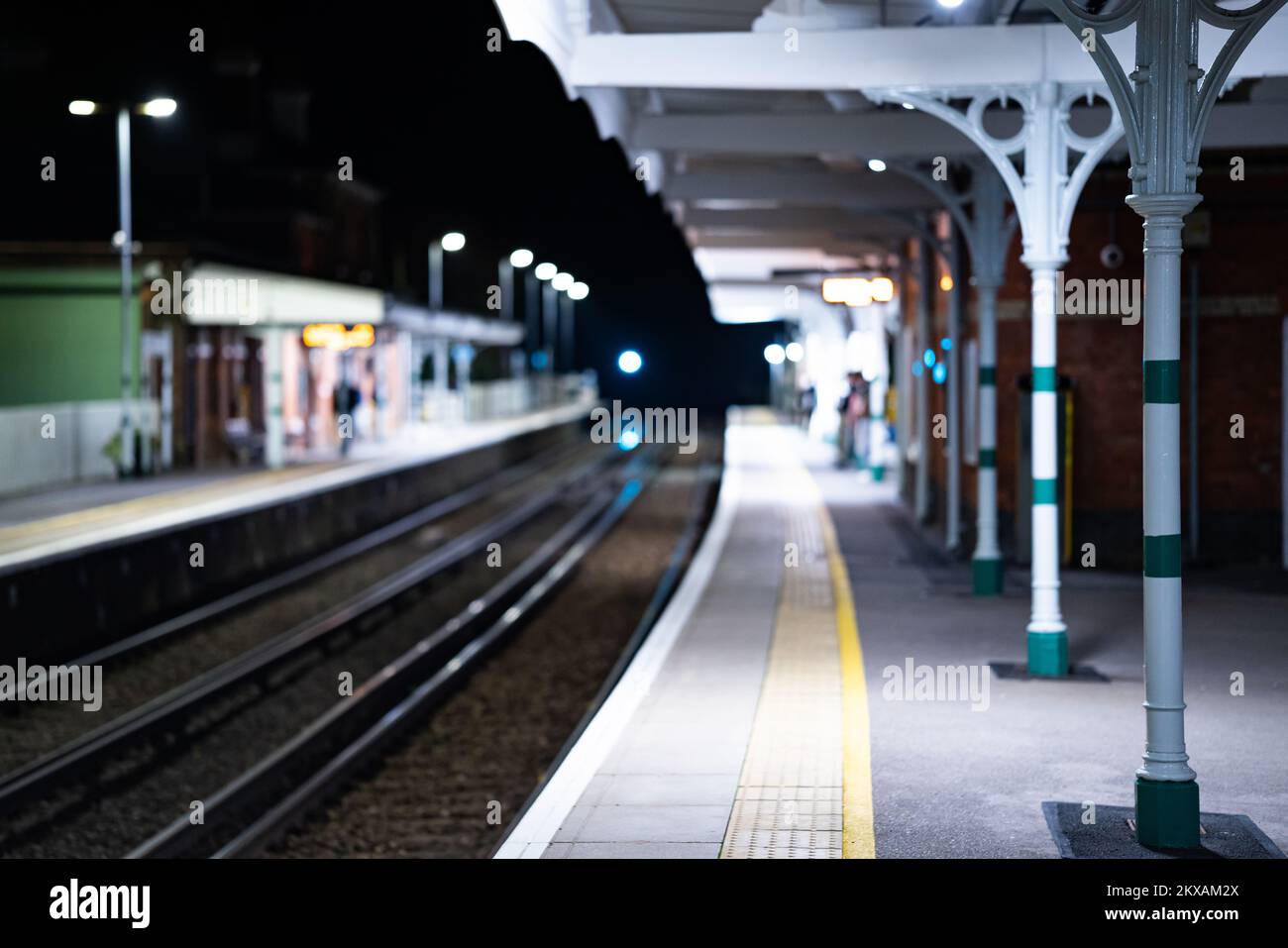 Night scene at small rural train station in West Sussex, England. UK ...