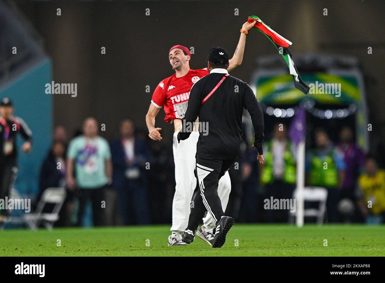 AL RAYYAN, QATAR - NOVEMBER 30: A pitch invader is seen with a flag of ...