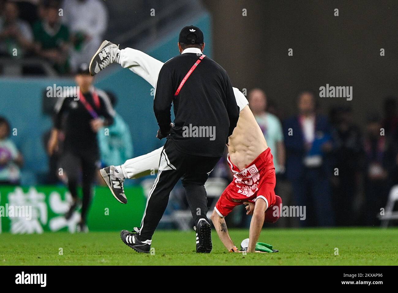 AL RAYYAN, QATAR - NOVEMBER 30: A pitch invader is seen with a flag of ...