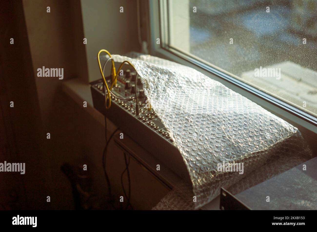 an electronic musical instrument covered with film and collecting dust ...