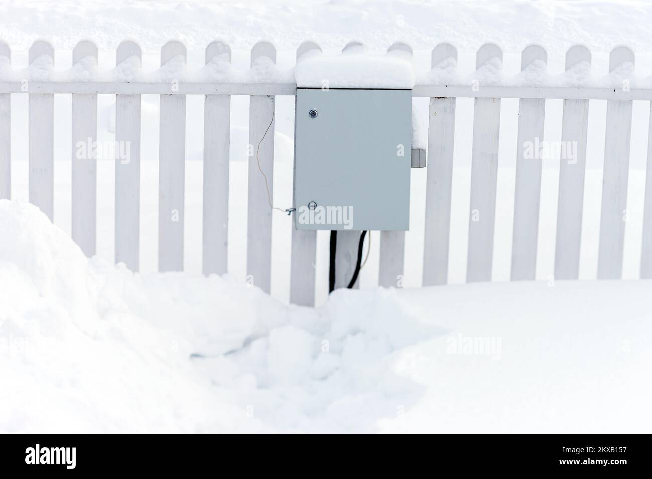 an electric metal meter box mounted on the fence, winter sce Stock ...